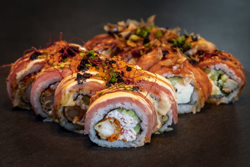 Assorted Sushi Rolls on a Black Slate Board with Creamy and Crispy ...