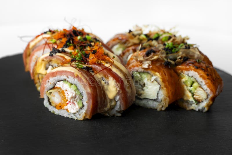 Assorted Sushi Rolls on a Black Slate Board with Creamy and Crispy ...