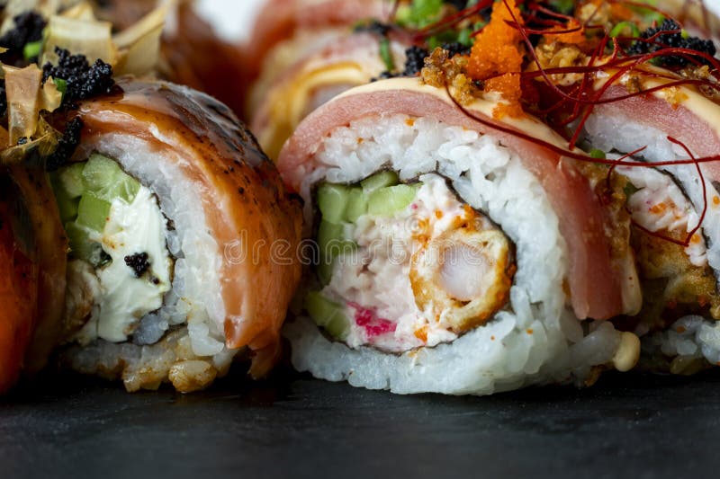 Assorted Sushi Rolls on a Black Slate Board with Creamy and Crispy ...