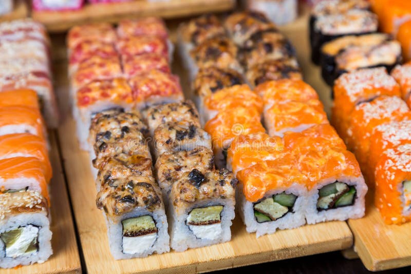 Assorted Sushi and Rolls on Wood Board in Dark Light Stock Image ...
