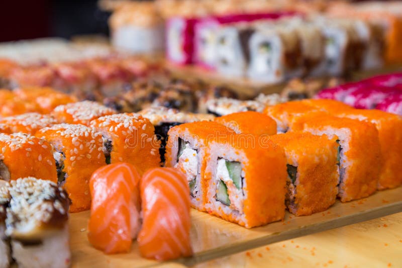 Assorted Sushi and Rolls on Wood Board in Dark Light Stock Photo ...