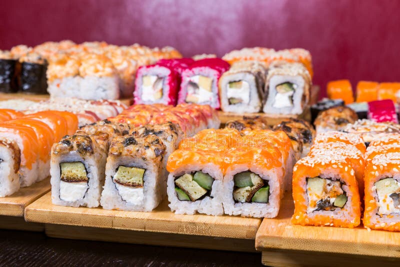 Assorted Sushi and Rolls on Wood Board in Dark Light Stock Image ...