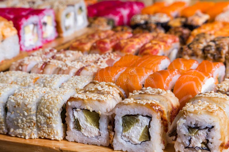 Assorted Sushi and Rolls on Wood Board in Dark Light Stock Image ...
