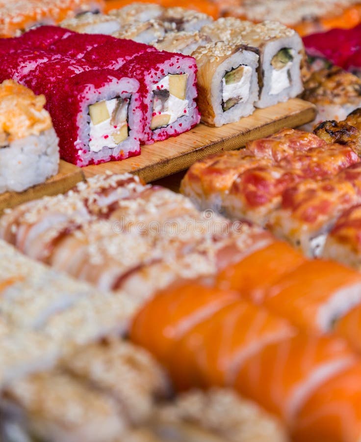 Assorted Sushi and Rolls on Wood Board in Dark Light Stock Image ...