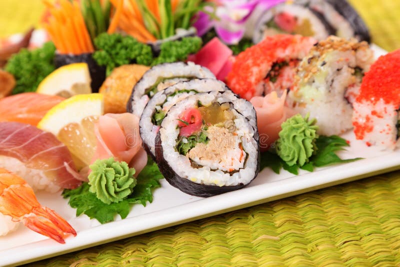 Assorted Sushi Selection on Bamboo Mat Stock Photo - Image of sesame ...
