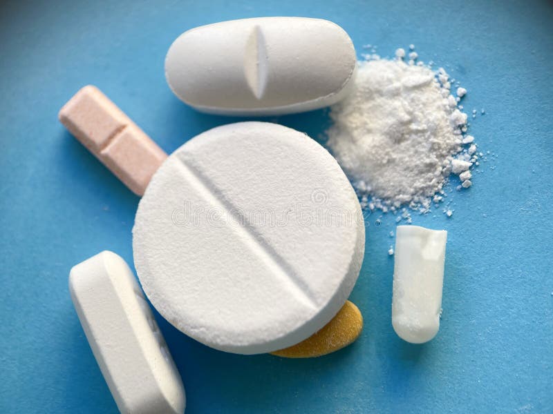 Assorted Tablets and Powder on Blue Surface Stock Photo - Image of ...