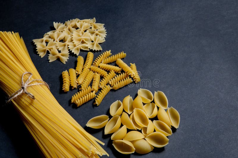 Assorted Types of Pasta on Black Background. Top View. Various Forms of ...