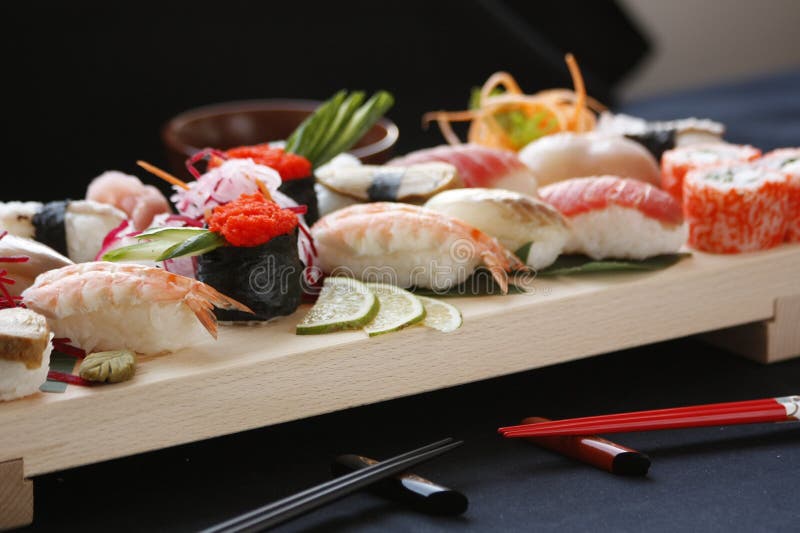 Assorted types of sushi on bamboo table with hashi chopsticks and shoyu ...