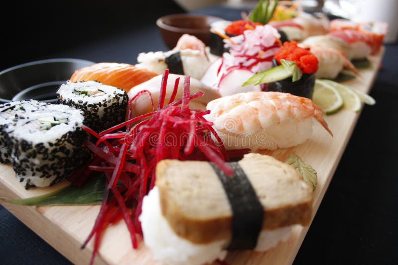 Assorted types of sushi on bamboo table with hashi chopsticks and shoyu ...