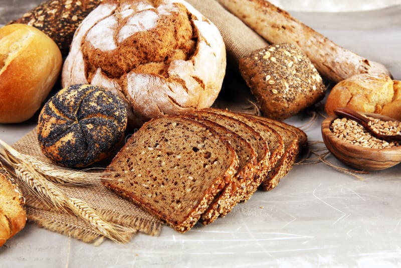 Assortment of Baked Bread and Bread Rolls and Cutted Bread on Table ...