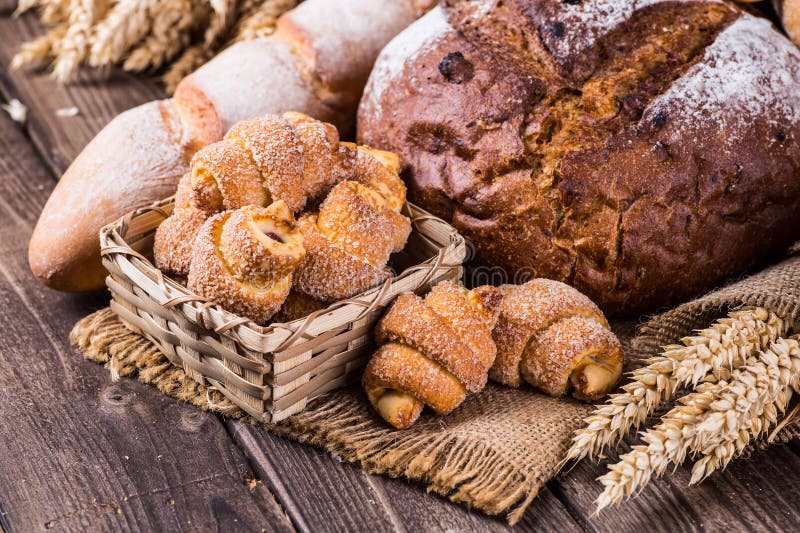 Assortment of Baked Bread on Wood Table Stock Photo - Image of breads ...