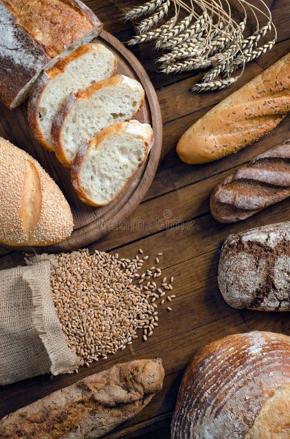 Assortment Bread Products and Wheat on Wooden Table Stock Image - Image ...