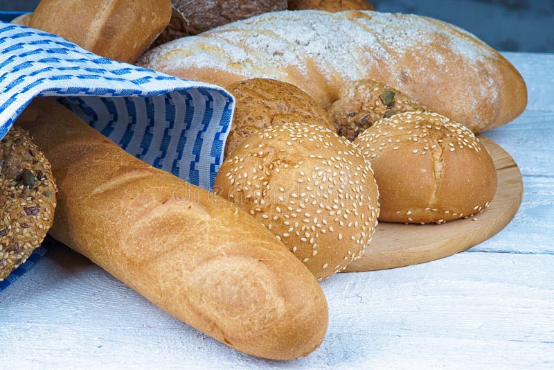 Assortment of Bread and Tablecloth on a Wooden Table Stock Photo ...