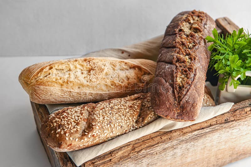 Assortment of Bread in a Wooden Old Rustic Box. Various Types of Greens ...