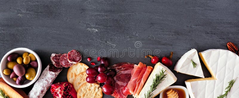 Assortment of Cheese and Meat Appetizers, Bottom Border on a Slate ...