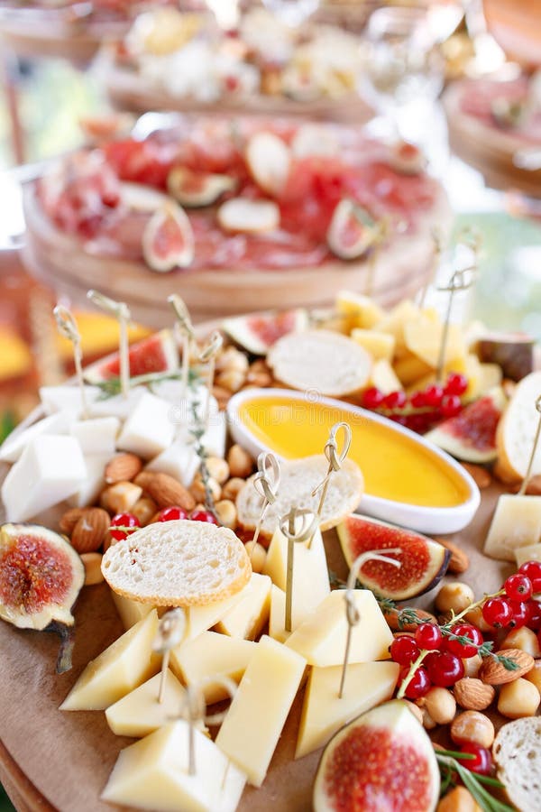 Assortment of Cheese on Wooden Board. Snacks on the Buffet Table Stock ...