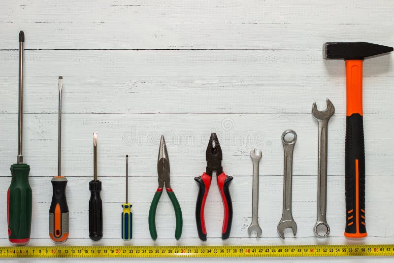 Assortment of Different Construction Tools on White Wooden Background ...