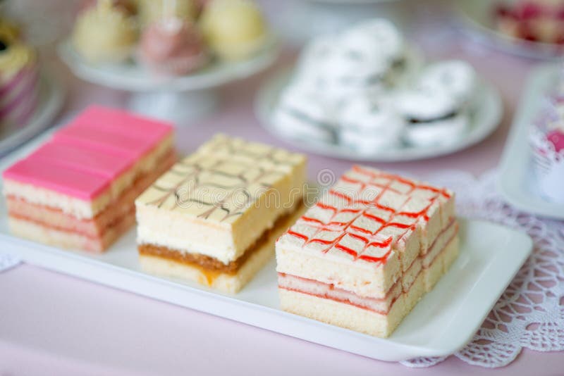 Assortment of Different Pink Mini Cream Cakes on Plate Stock Photo ...