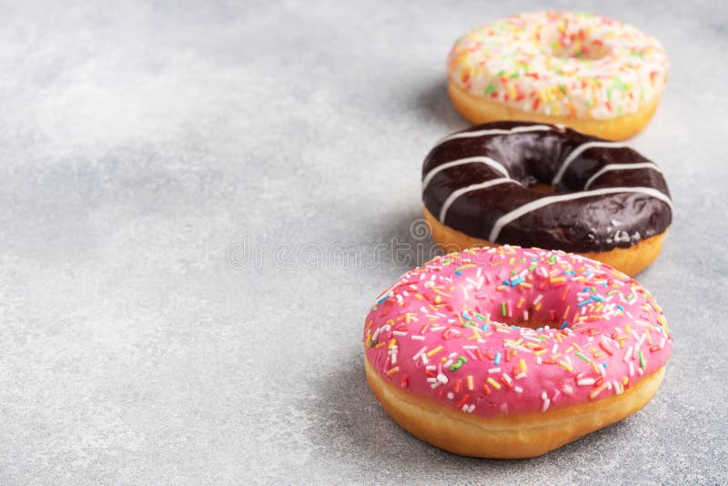 Assortment of Donuts in Icing on a Gray Concrete Table, Copy Space ...