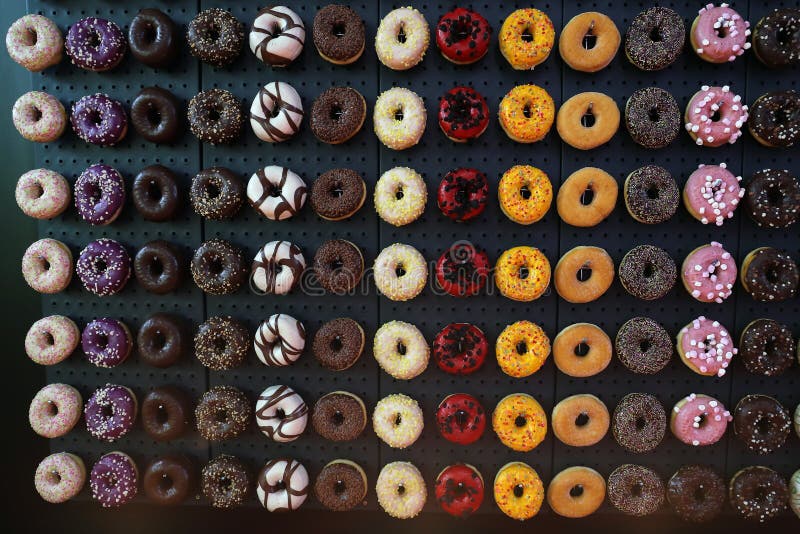 Assortment of Donuts with Various Colors and Toppings Stock Photo ...
