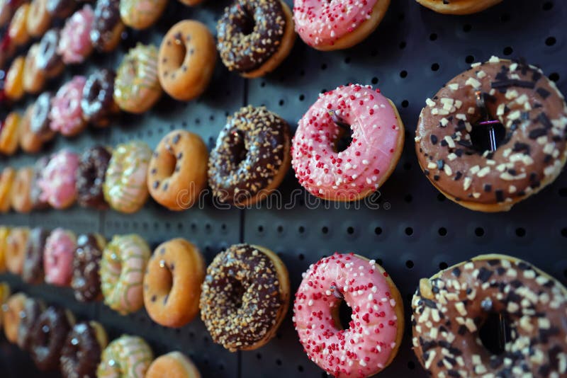 Assortment of Donuts with Various Colors and Toppings Stock Photo ...