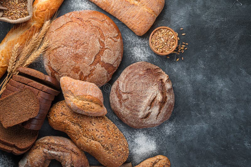 Assortment of Fresh Bread and Wheat on a Dark Background. Stock Image ...