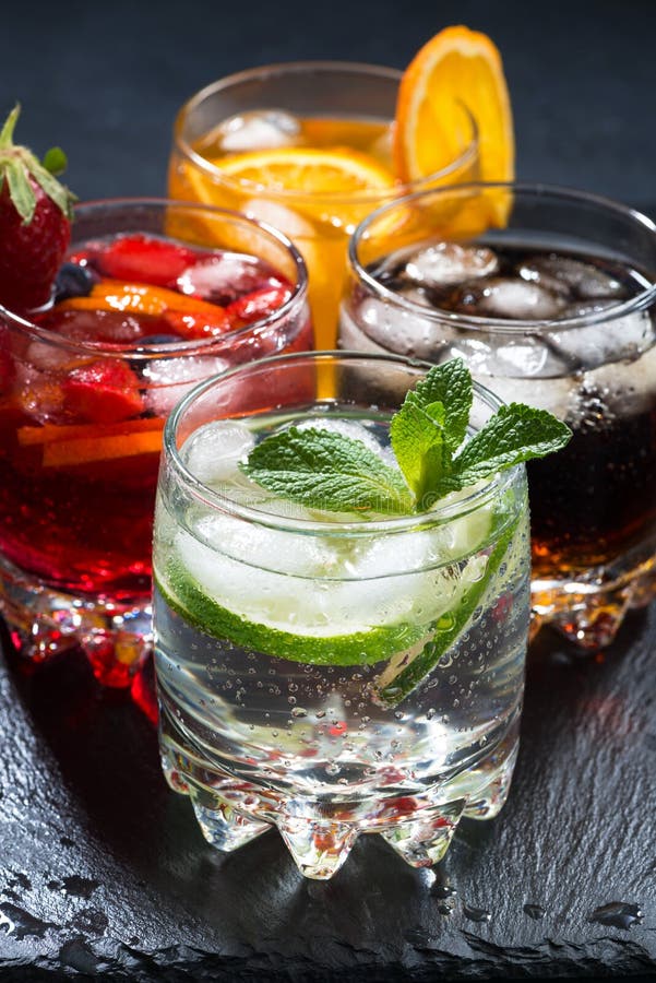 Assortment of Iced Fruit Drinks on a Dark Background, Vertical Stock ...