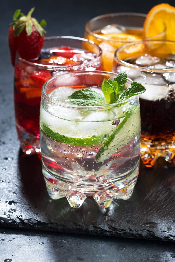 Assortment of Iced Fruit Drinks on a Dark Background, Vertical Stock ...