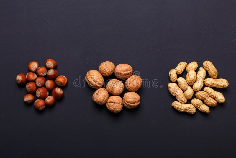 Assortment of Nuts on a Black Background - Healthy Snack. Heart of Nuts ...