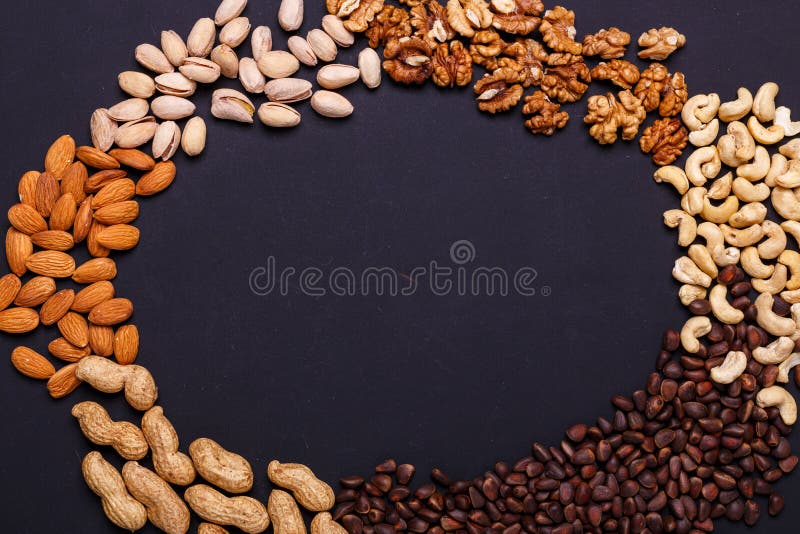 Assortment of Nuts on a Black Background - Healthy Snack. Heart of Nuts ...