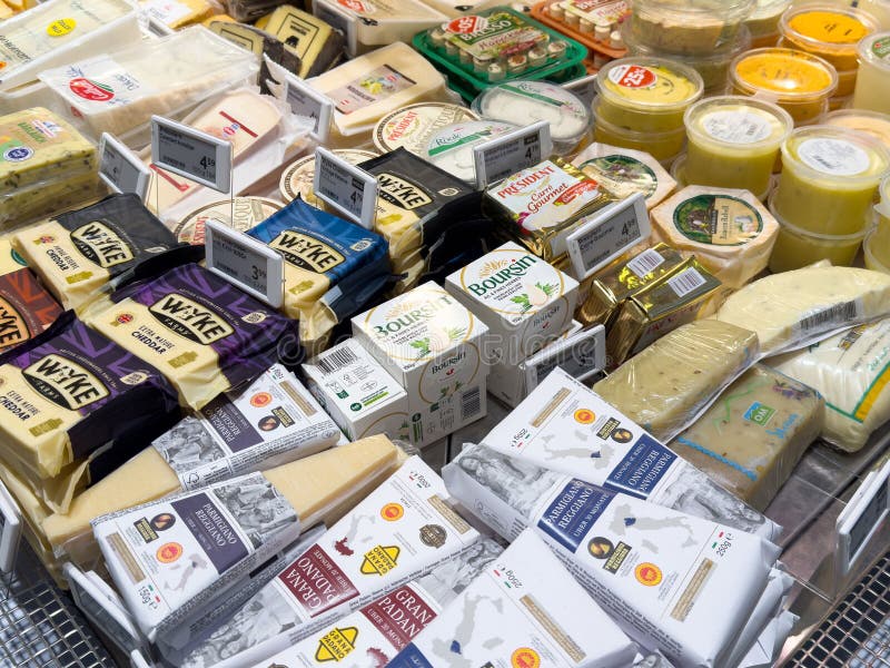 Assortment of Packaged Cheeses on Display in Grocery Store Editorial ...