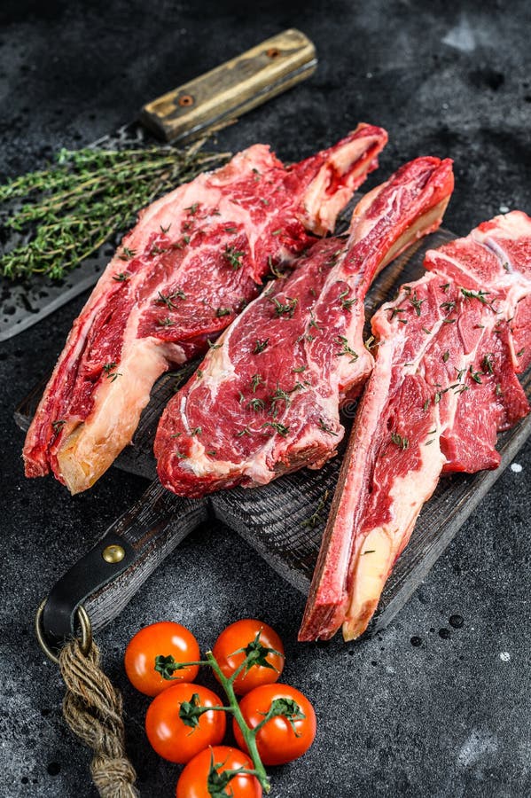 Assortment of Raw Cuts Beef Meat Steaks on the Bone. Black Background ...