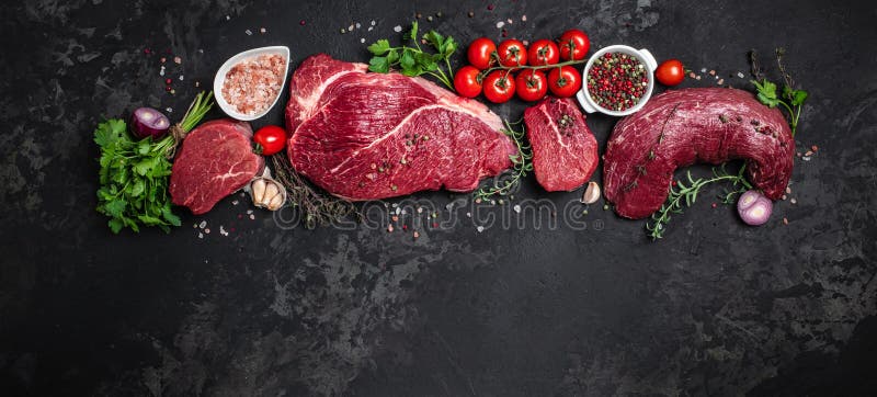 Assortment of Raw Cuts of Raw Beef Meat Steaks with Spices on a Dark ...