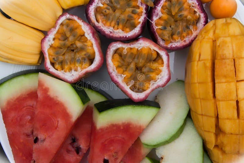 Assortment of Sliced Tropical Fruits on Plate. Stock Photo - Image of ...