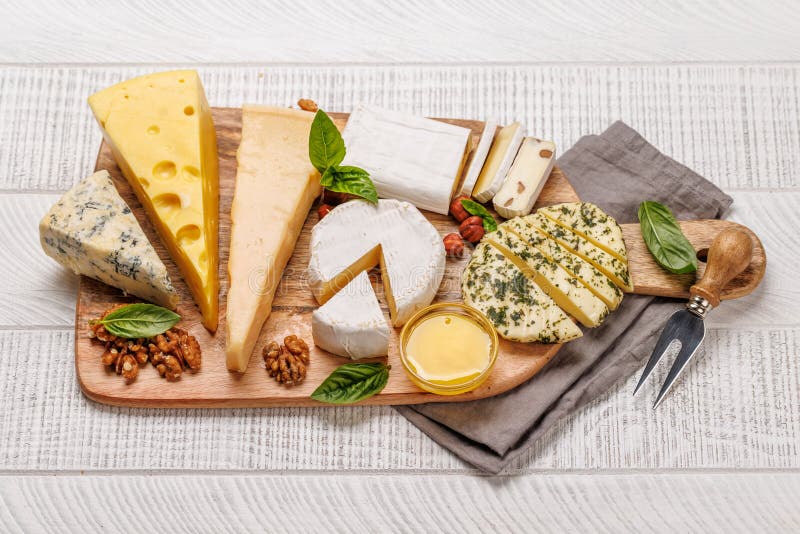 An Assortment of Various Cheeses Arranged on a Board, Highlighting ...