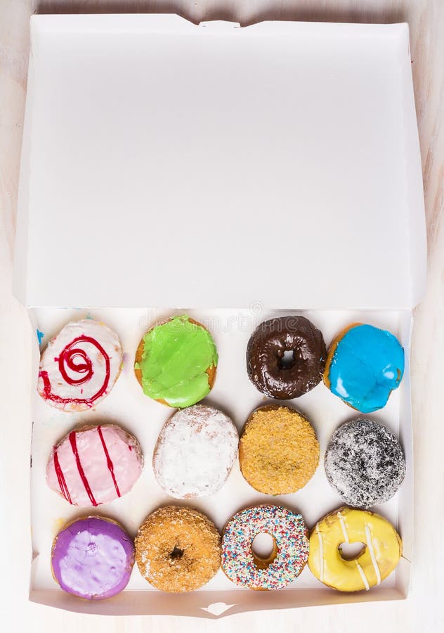 Assortment of Various Colorful Donuts in a White Paper Box , Top View ...