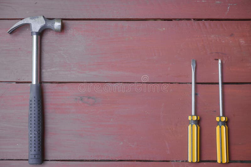 Assortment of Well-used Hand Tools Spread Out on a Worn Wooden Surface ...