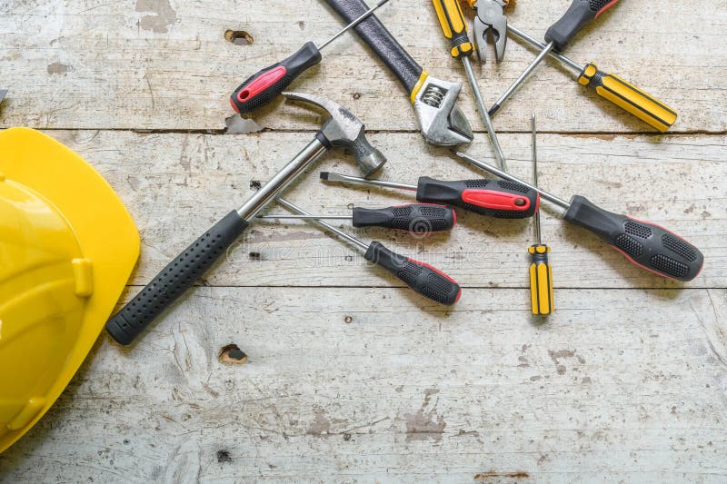 Assortment of Well-used Hand Tools Spread Out on a Worn Wooden Surface ...