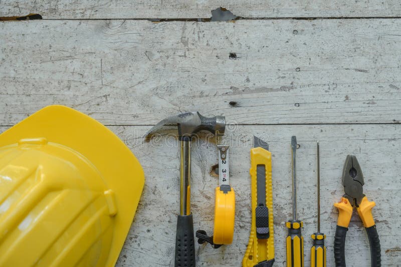 Assortment of Well-used Hand Tools Spread Out on a Worn Wooden Surface ...
