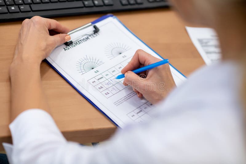 Eye Doctor Making Notes after Making Astigmatism Test for Patient Stock ...