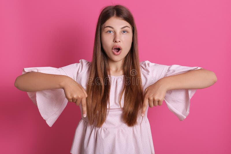 Astonished Excited Good Looking Girl Pointing Fingers Down Posing With