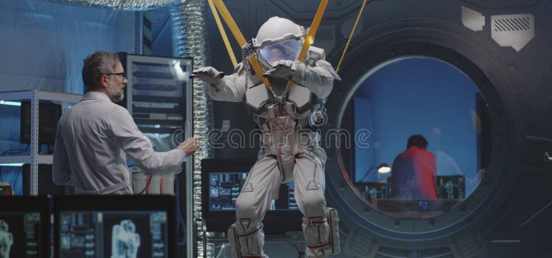 Astronaut Moving Limbs while Hanging on Bands Stock Photo - Image of ...