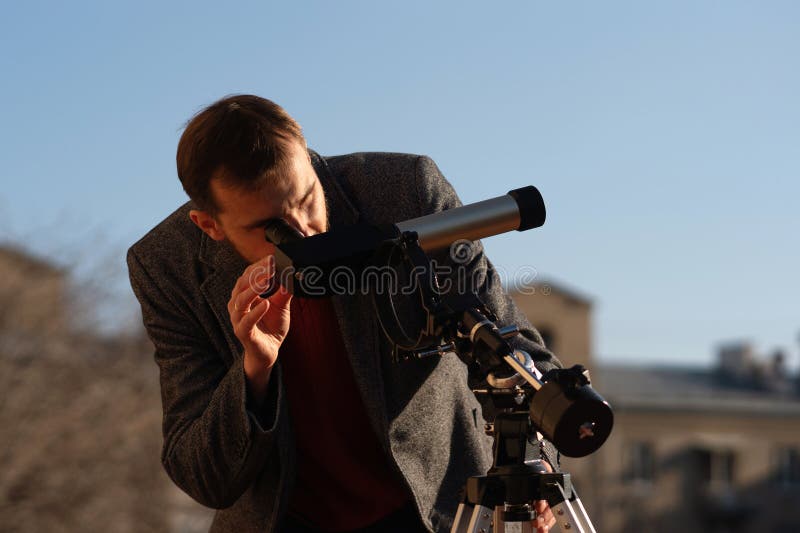 Astronomer Adjusts Specialized Telescope on City Rooftop To Study Sun ...