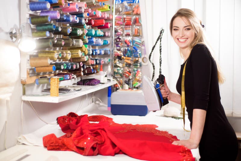 Atelier Design Studio on Tailoring. the Designer Steams the Fabric ...