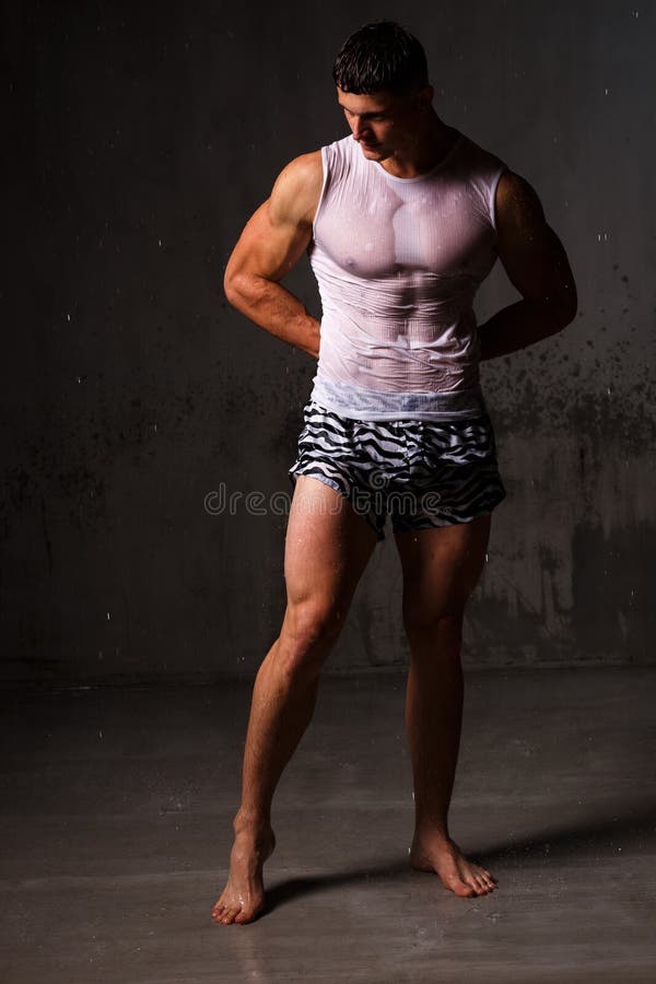 Athlete Bodybuilder Trains in the Studio in the Rain. Stock Photo ...