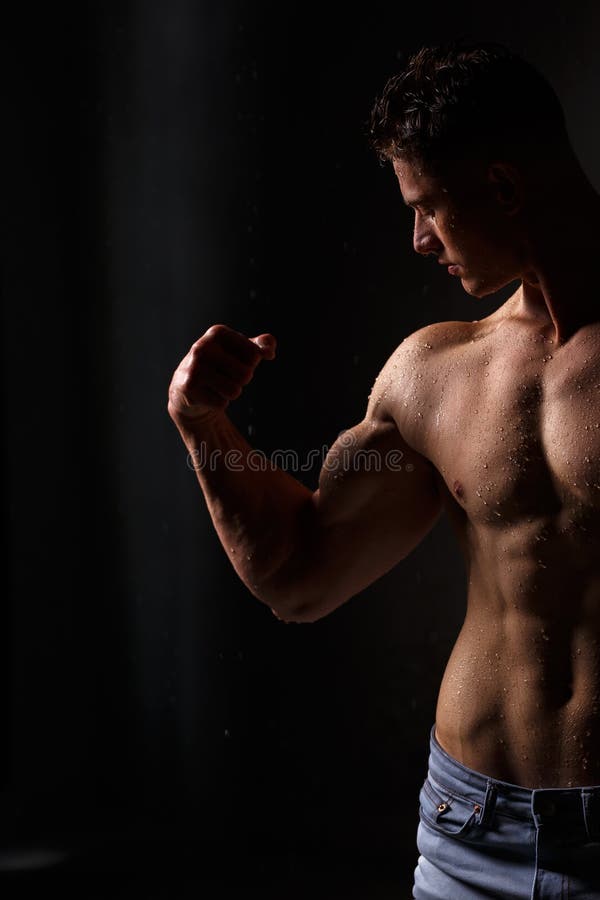 Athlete Bodybuilder Trains in the Studio in the Rain. Stock Photo ...