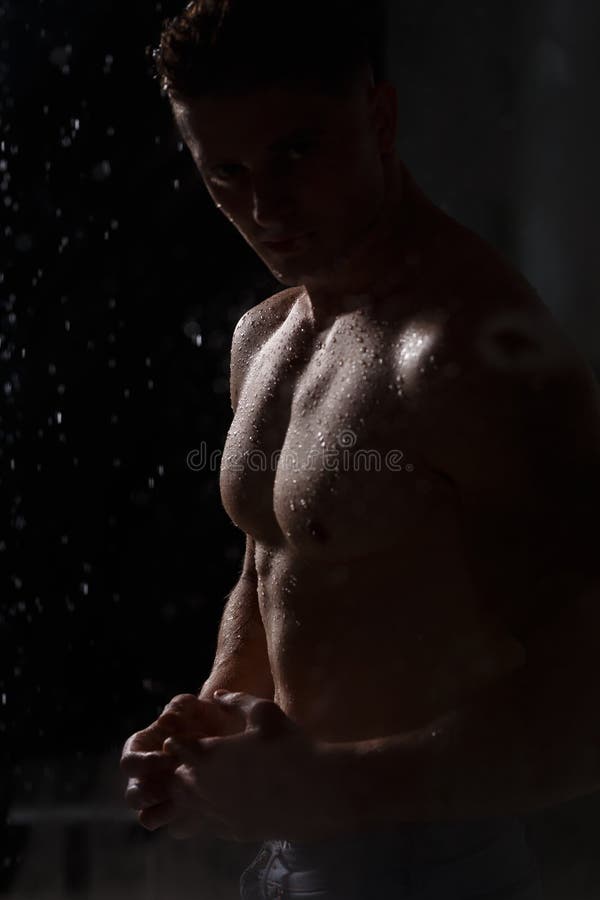 Athlete Bodybuilder Trains in the Studio in the Rain. Stock Photo ...