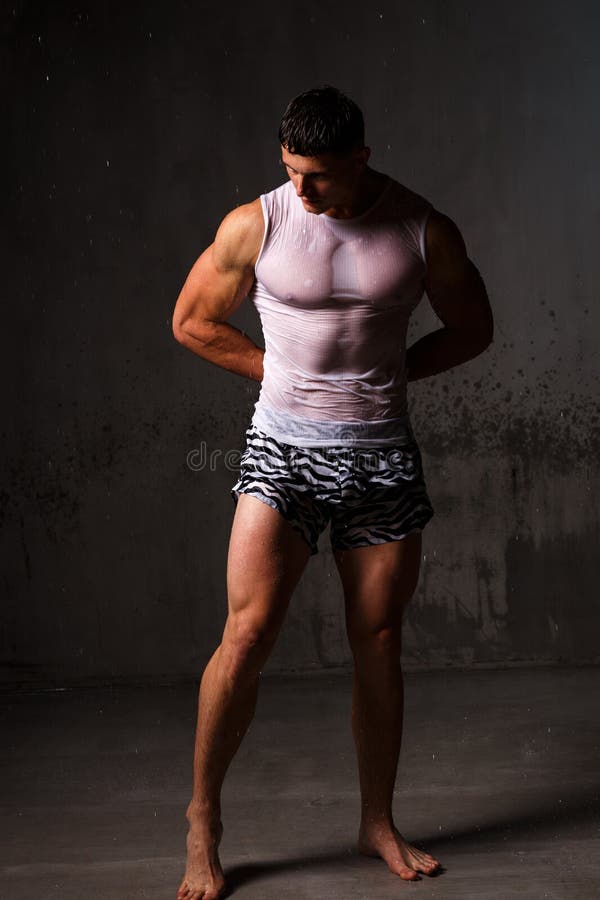 Athlete Bodybuilder Trains in the Studio in the Rain. Stock Image ...