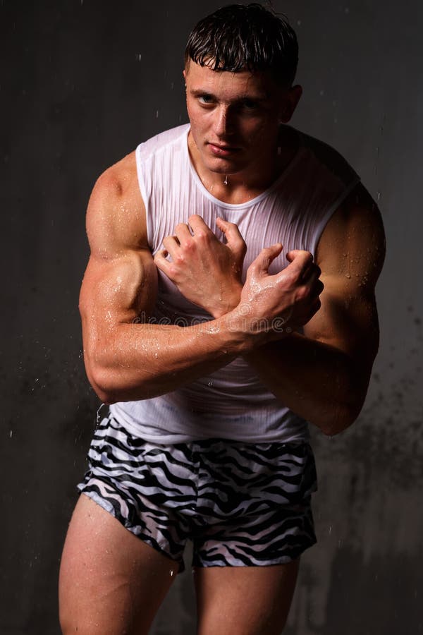 Athlete Bodybuilder Trains in the Studio in the Rain. Stock Image ...