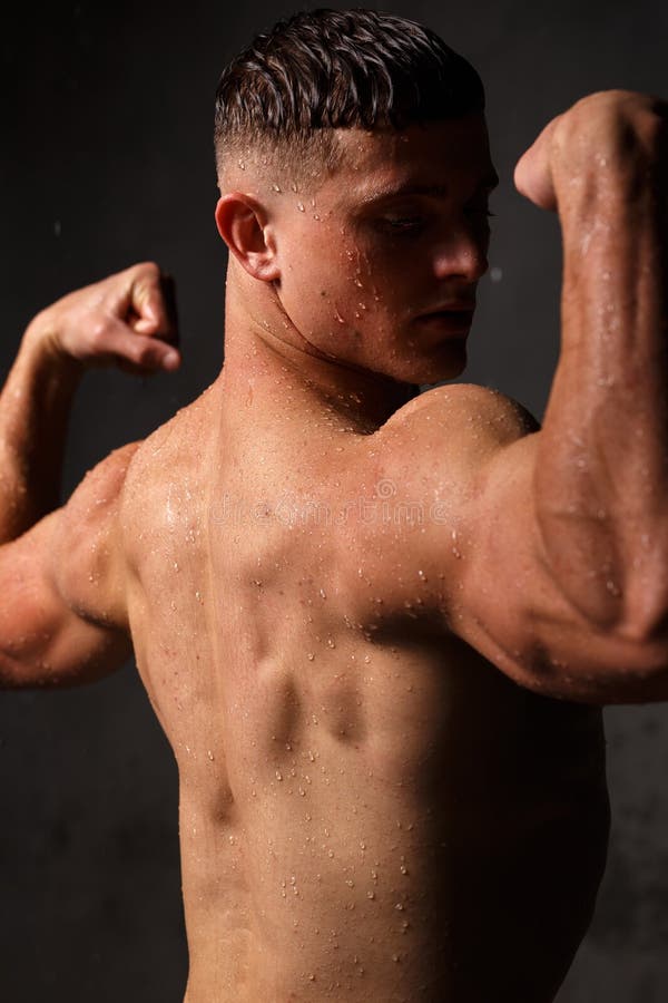 Athlete Bodybuilder Trains in the Studio in the Rain. Stock Photo ...